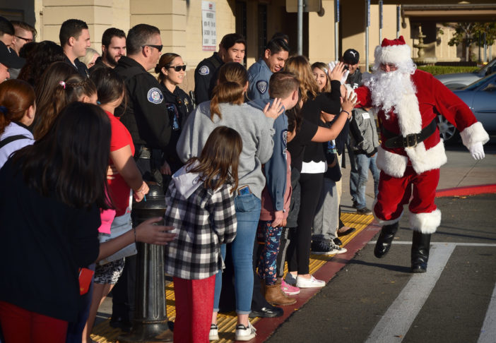 Santa’s helpers wear uniforms at Westminster’s Shop with a Cop event ...